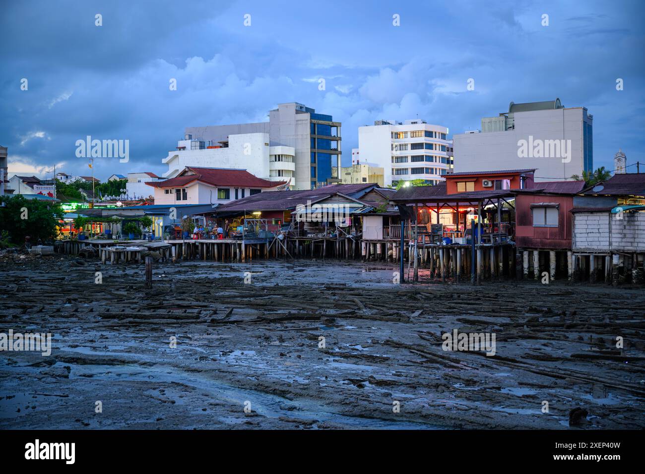 Rustic houses on stilts at the Chew Jetty taken from the Tan Jetty at dusk, George Town, Penang ...