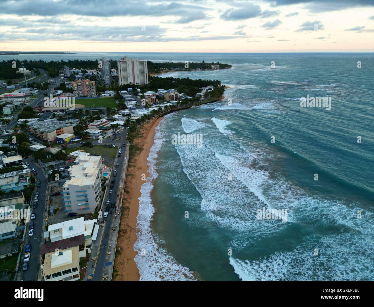 luquillo beach with ocean water, sand and palm trees (resort town in ...