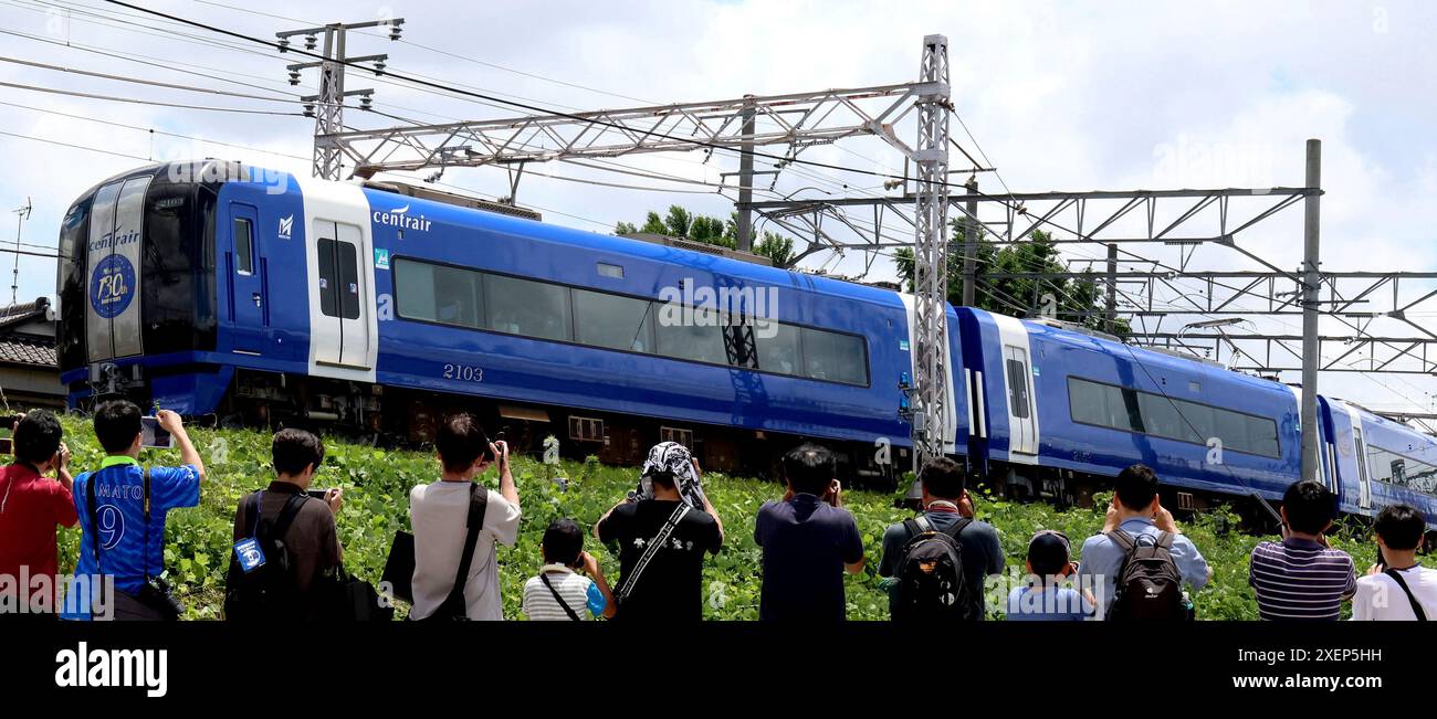 A group of train spotters take photos of "Blue μSky" unveiled by ...