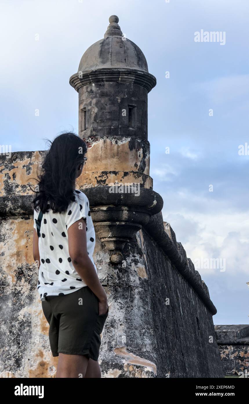 woman looking at bastion tower at castillo san felipe del morro castle ...