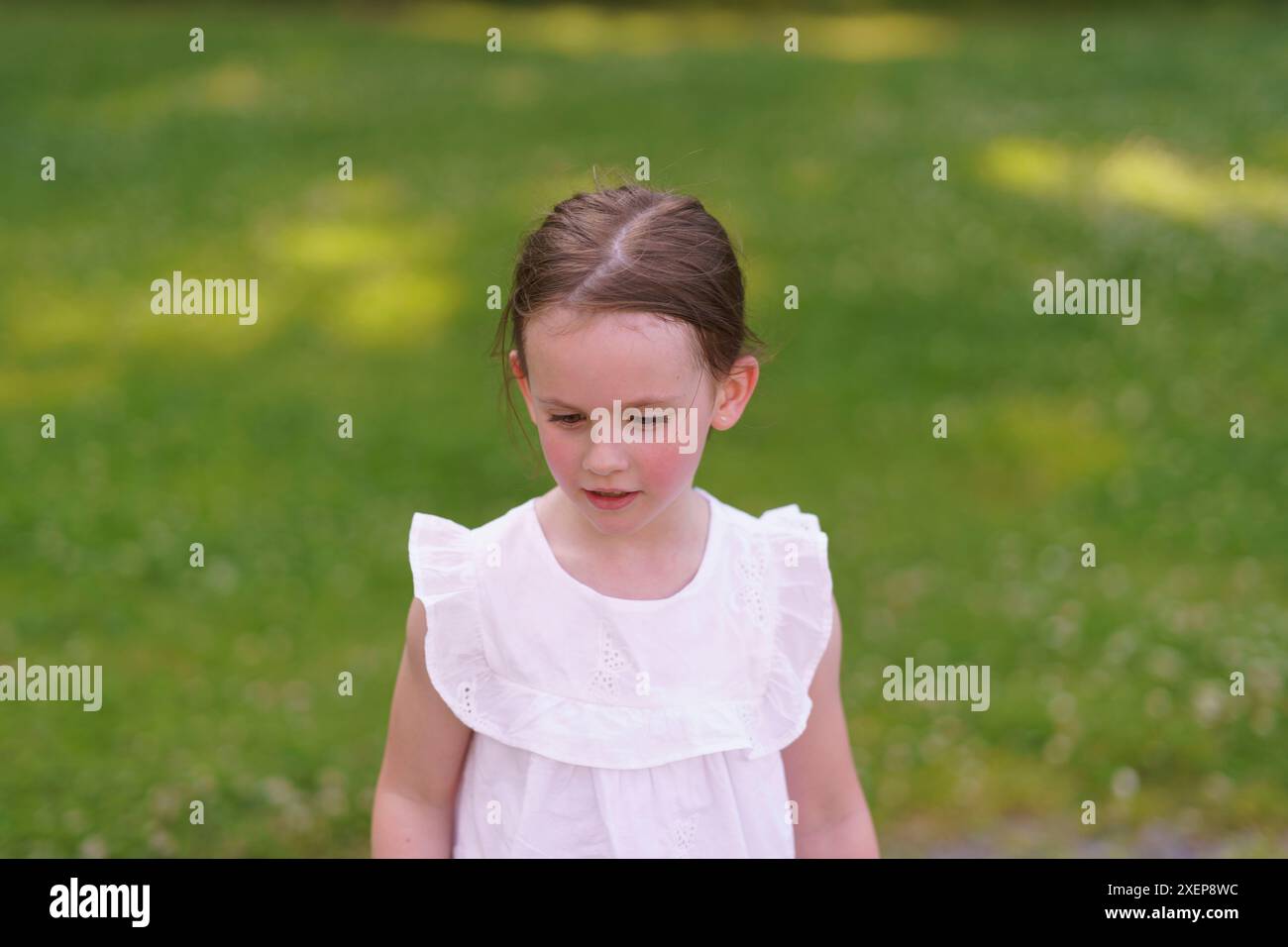 A cheerful preschooler, one tooth absent, enjoying a sun-soaked day at ...