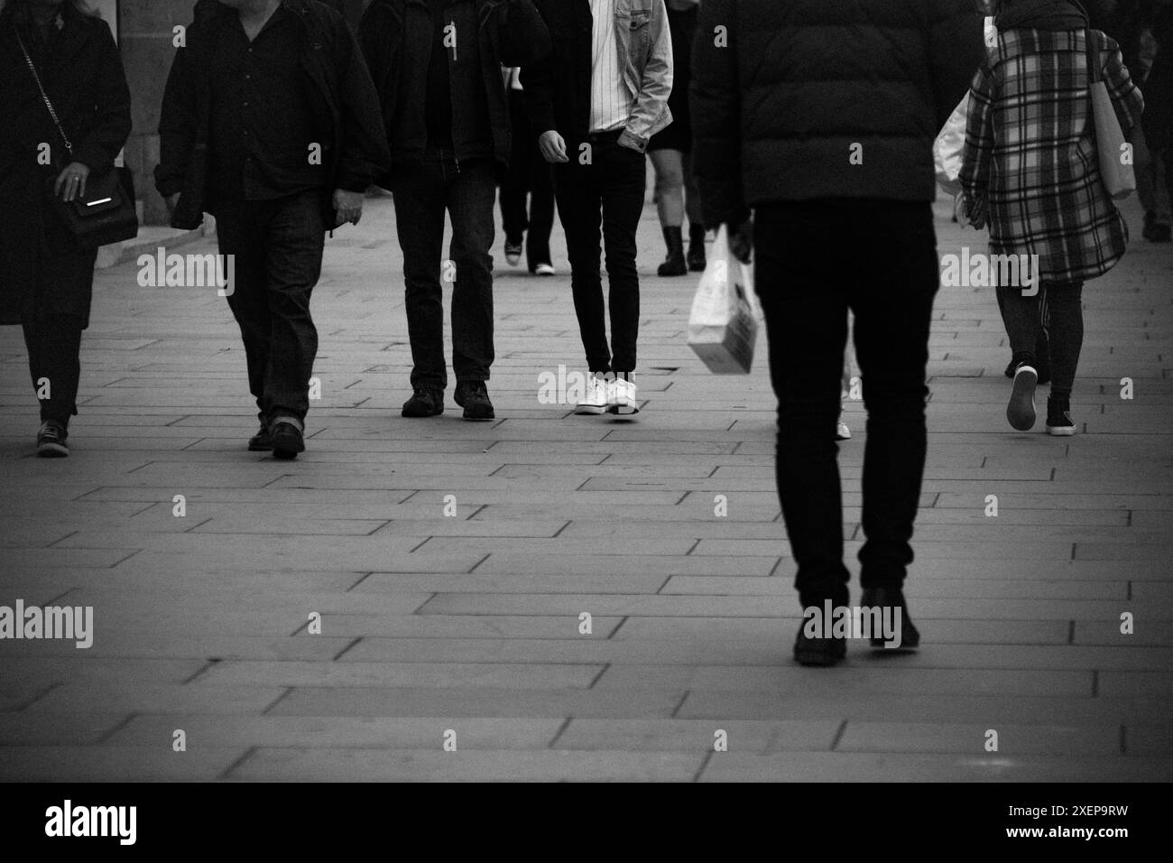 legs of pedestrians and shoppers walking along the pavement Stock Photo ...
