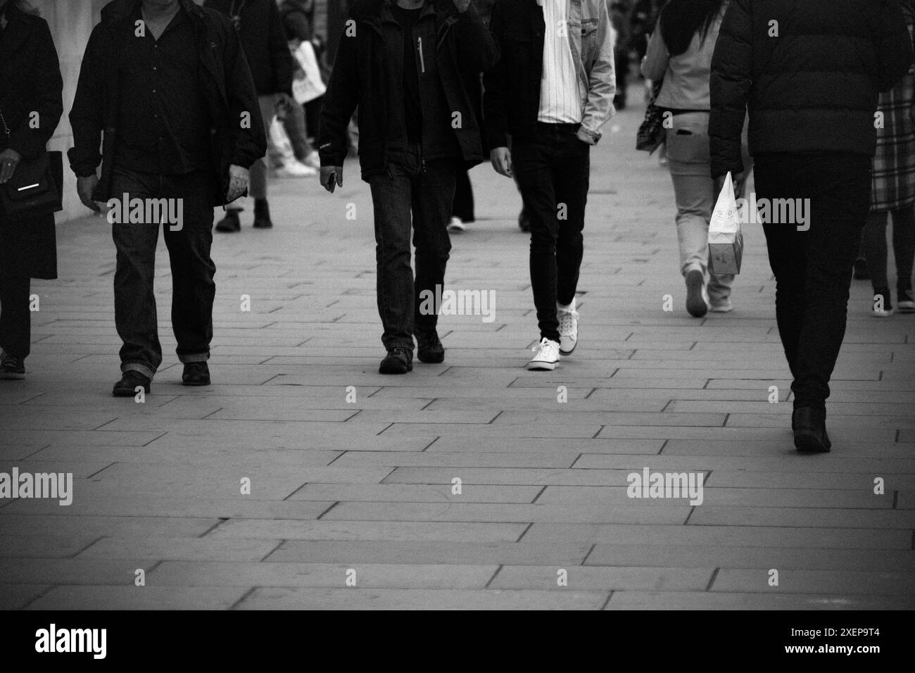legs of pedestrians and shoppers walking along the pavement Stock Photo ...