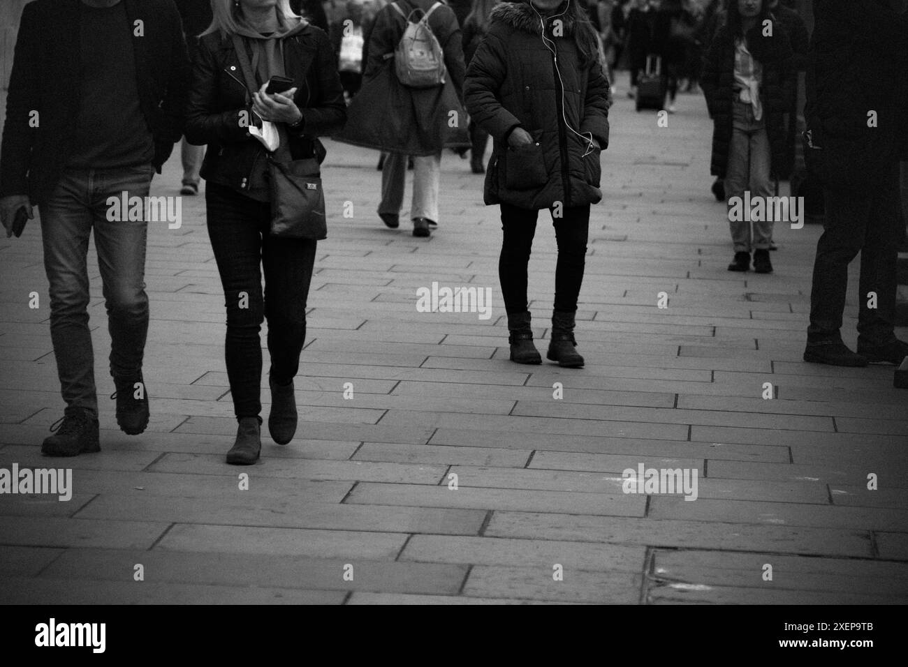 legs of pedestrians and shoppers walking along the pavement Stock Photo ...