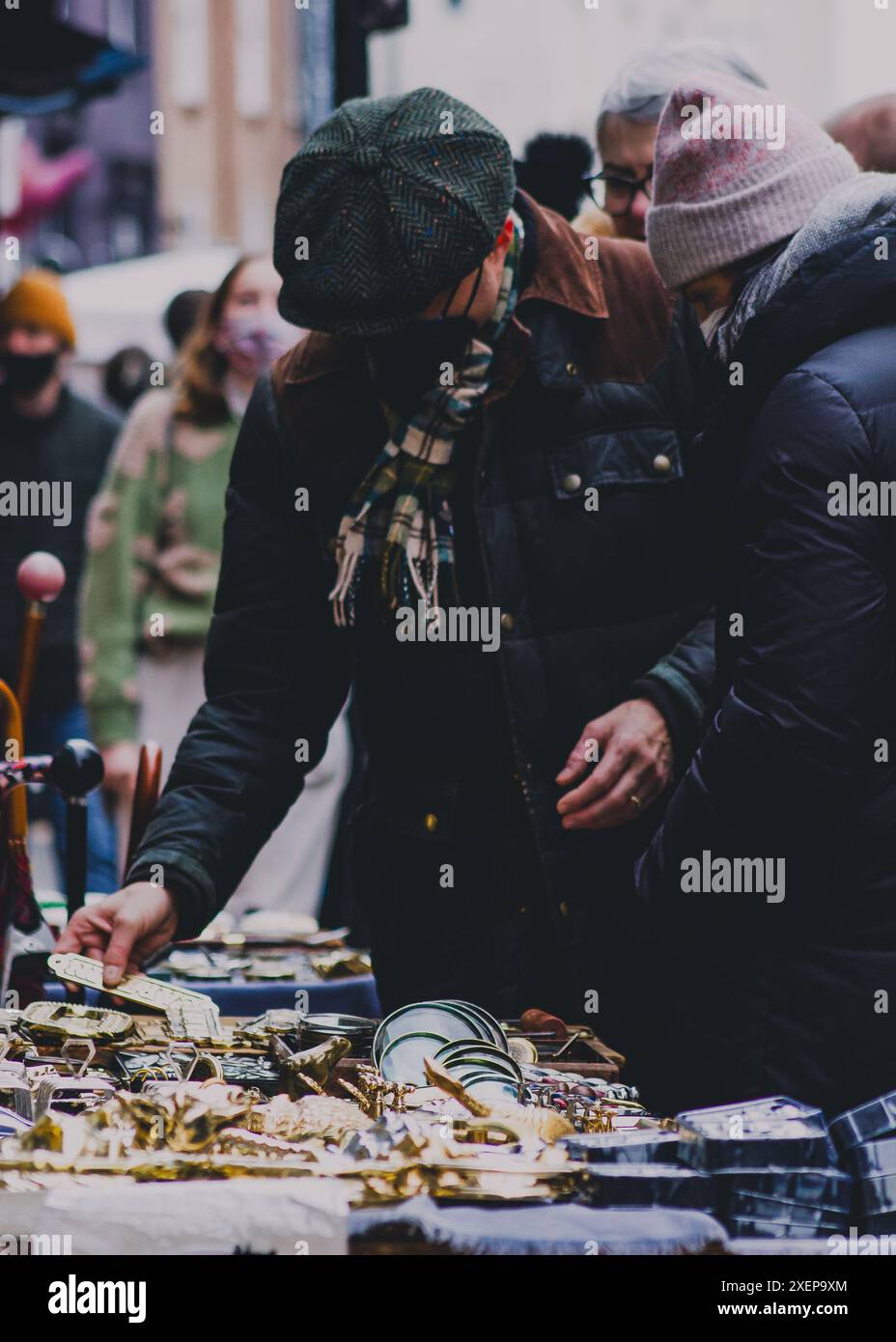Shoppers examine vintage , antique and retro goods on a London market ...