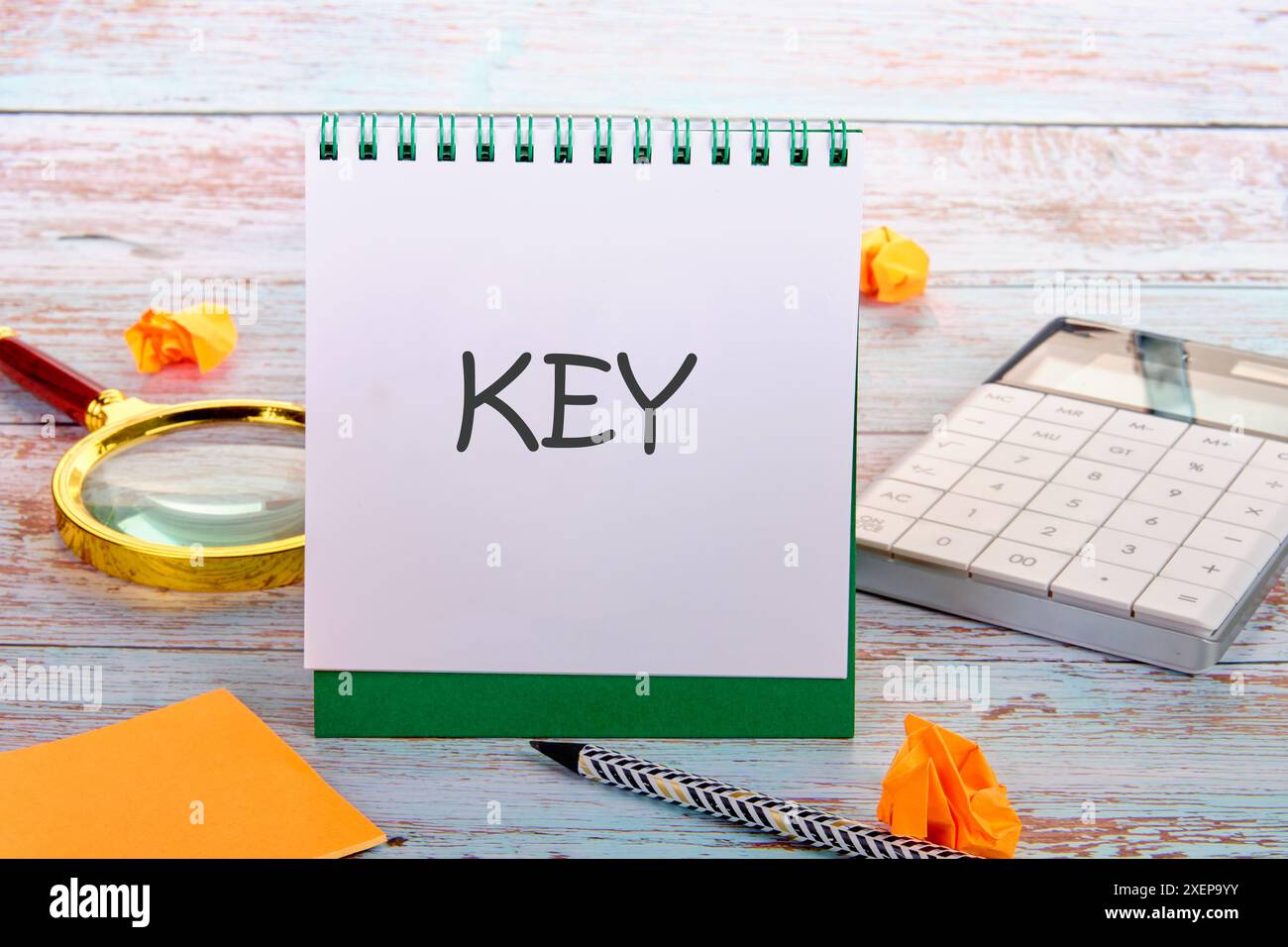 The text KEY in an upright notebook in a composition with office ...
