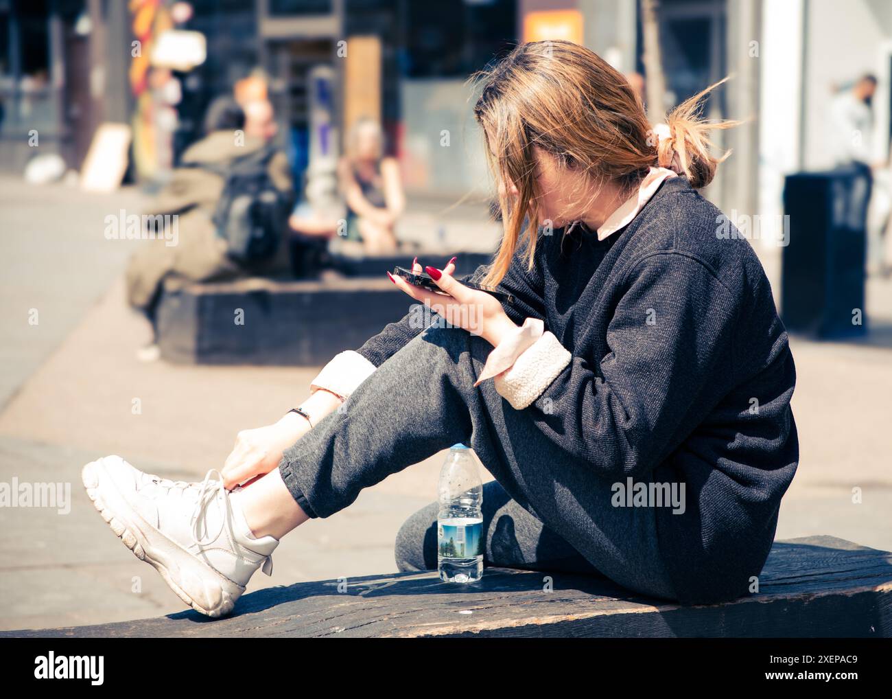 Woman sits alone outside hi-res stock photography and images - Alamy