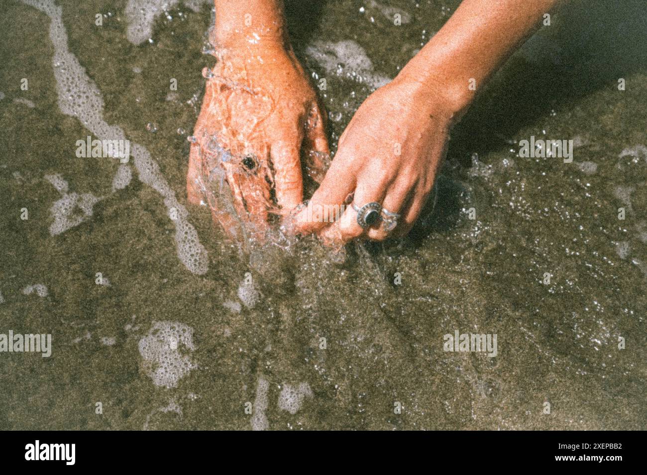 Woman hands sea sand water hi-res stock photography and images - Alamy