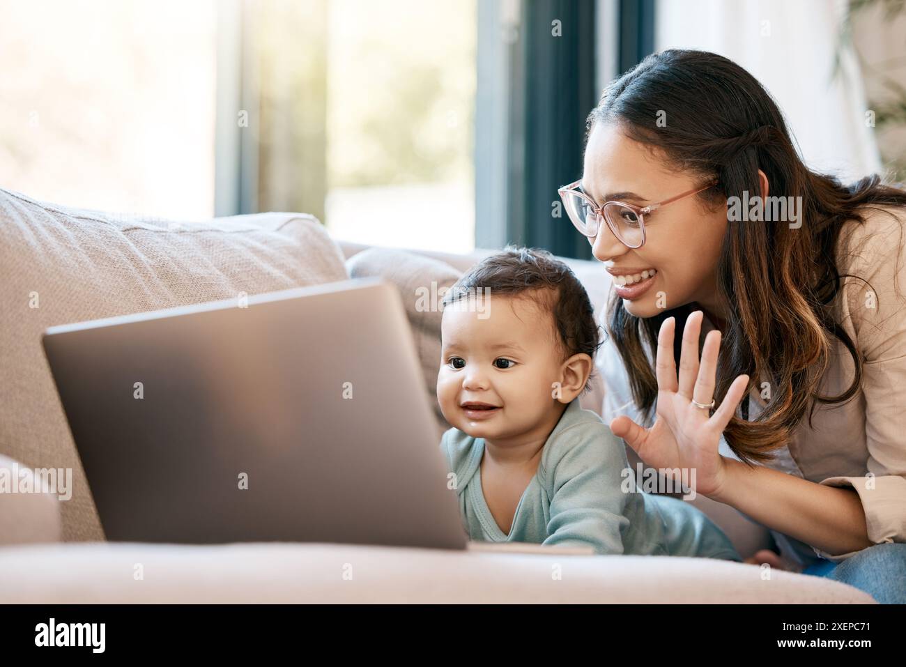 Mother, baby and laptop on couch for video call, greeting and online ...
