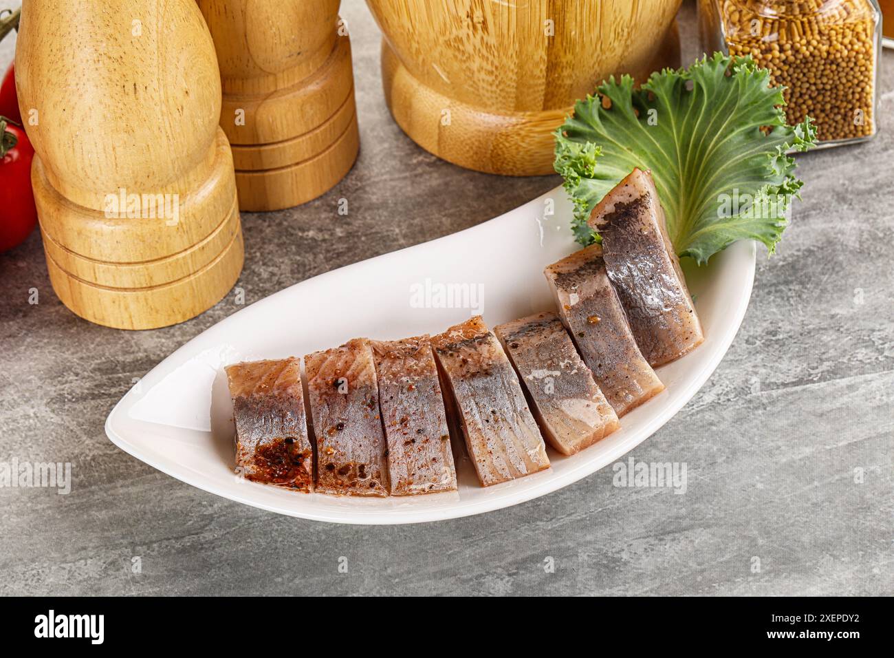 Sliced spicy salted herring fillet snack Stock Photo - Alamy