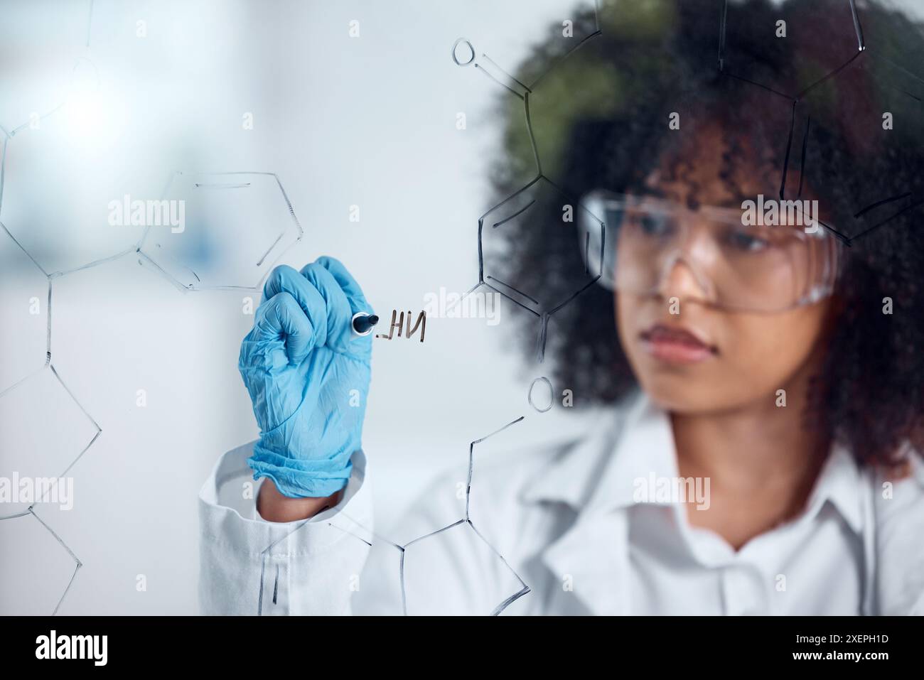 Woman, science and writing equation on glass, problem solving and scientist in laboratory for ...