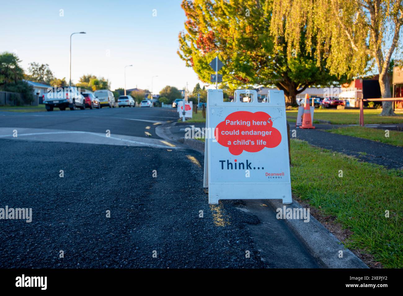 Small sandwich board signs on the street edge outside a primary school ...