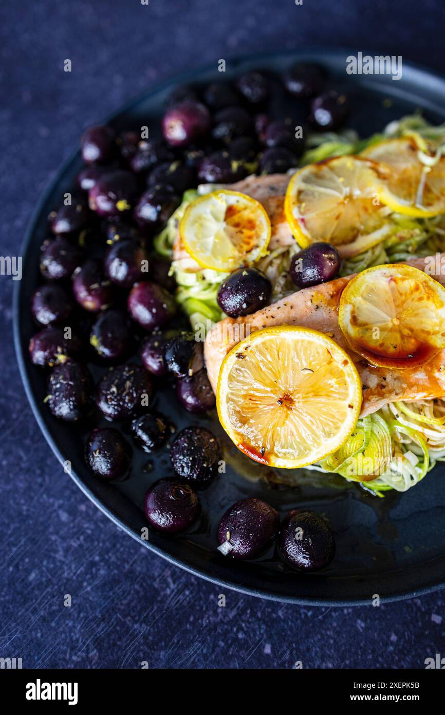 Salmon with leeks and blistered grapes Stock Photo - Alamy