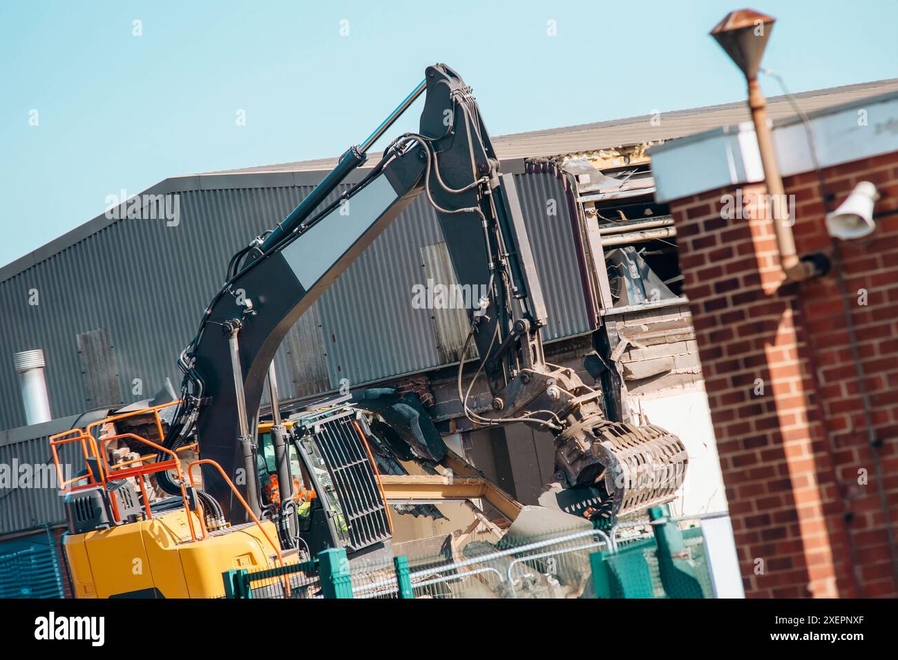 Demolition of building. Excavator breaks old house. Making space for ...