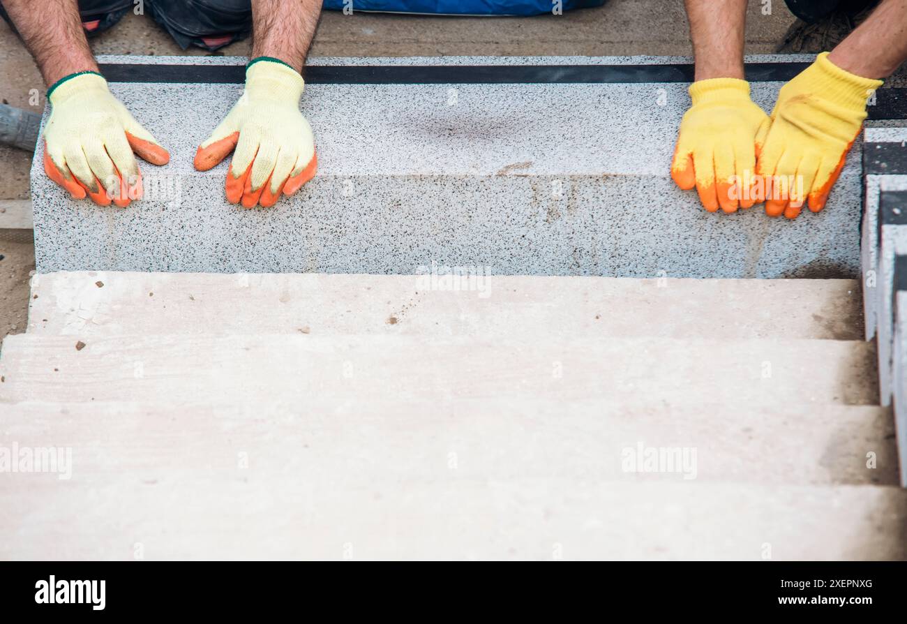 Concrete steps under construction as a team of builders install heavy ...