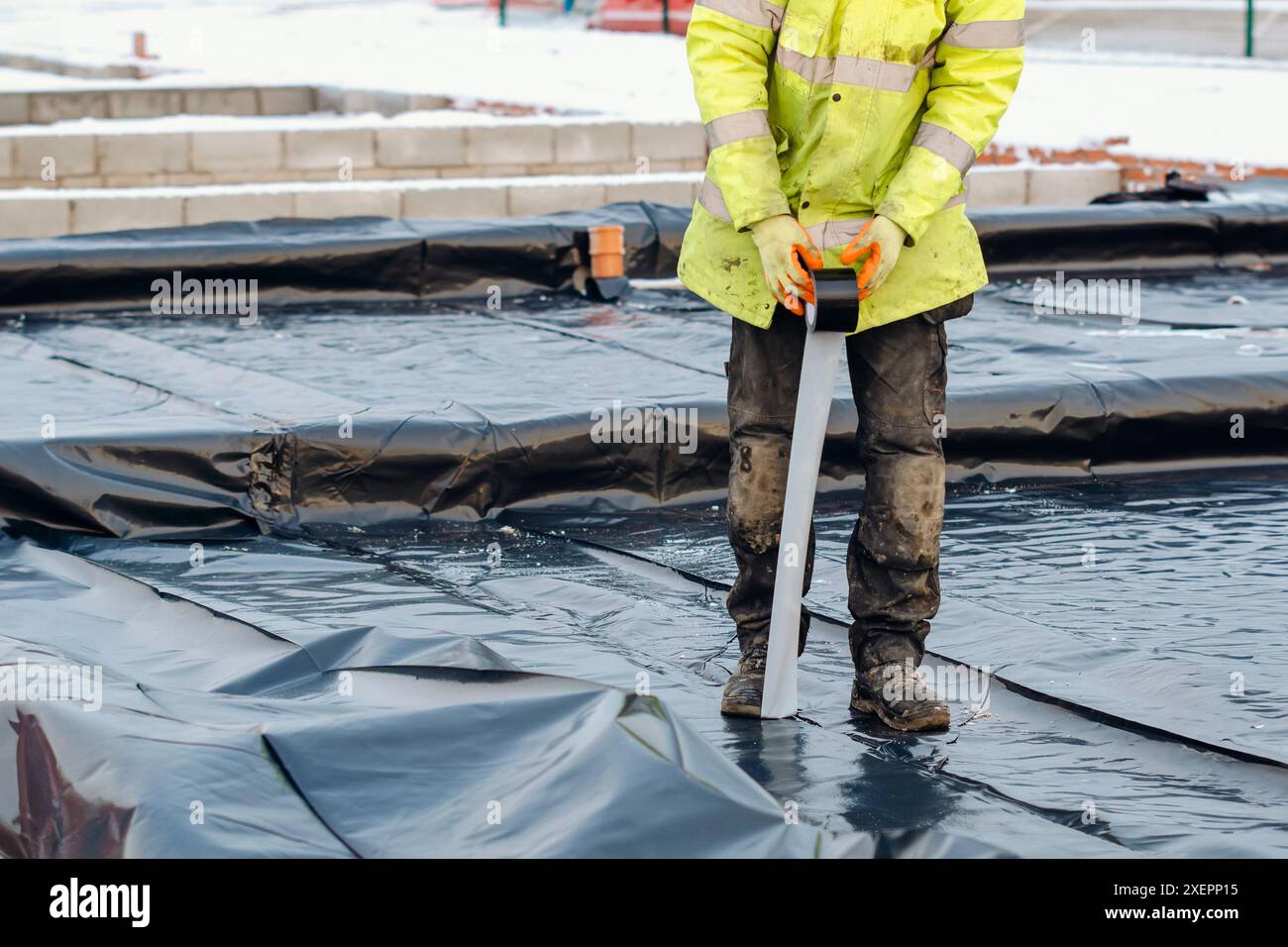 Waterproof installation at new house construction. Builders installing ...