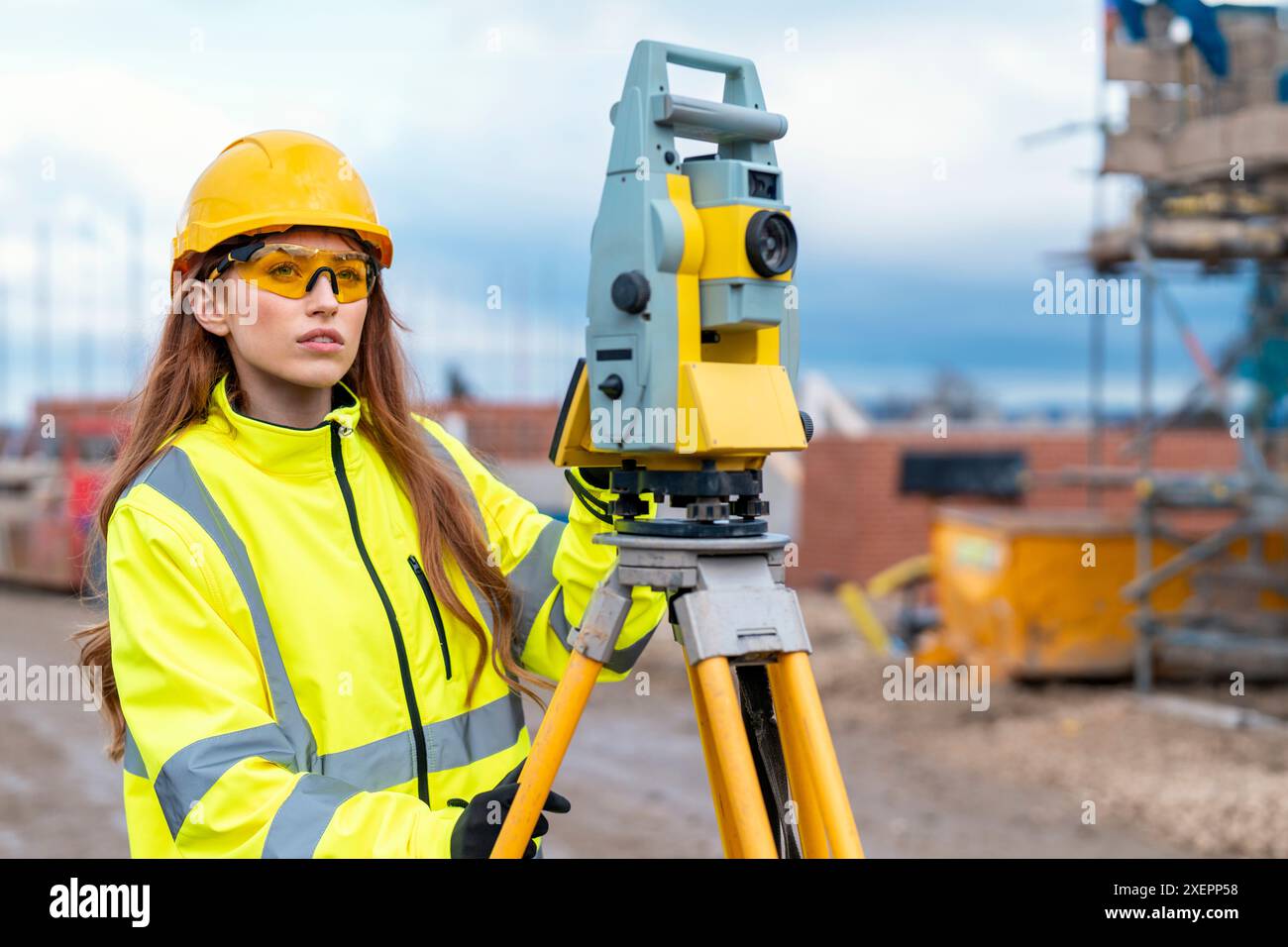 Female site engineer surveyor working with theodolite total station EDM ...
