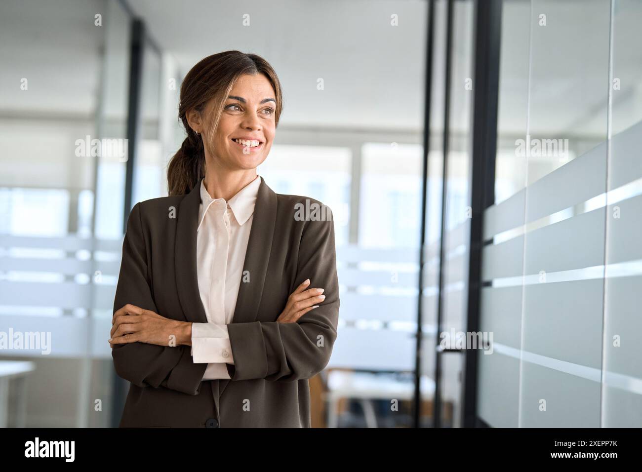 Happy 45 years old business woman leader standing in office looking ...