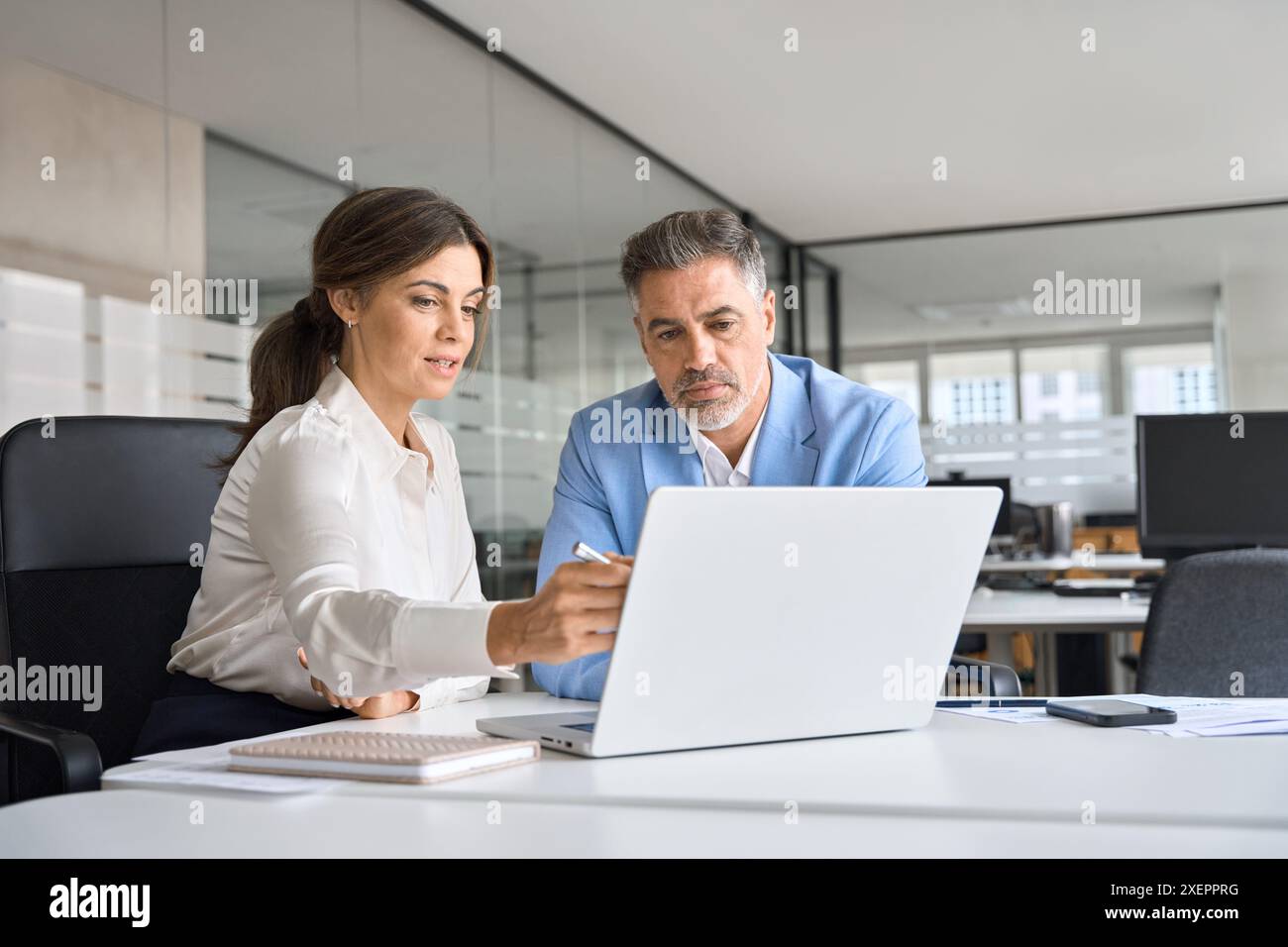 Two busy executive team business people working on computer at office ...