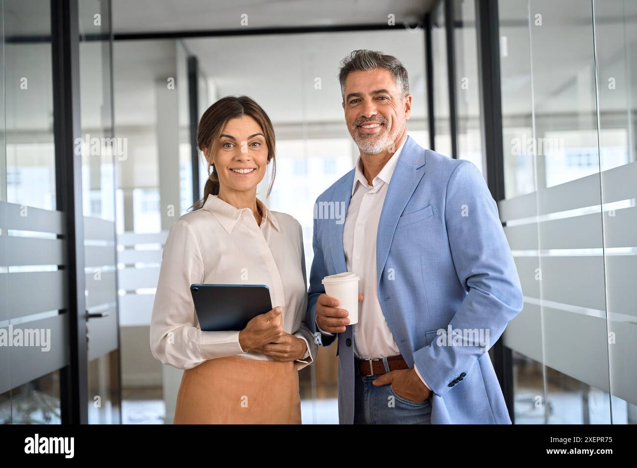 Portrait of two happy executives business man and woman partners in ...