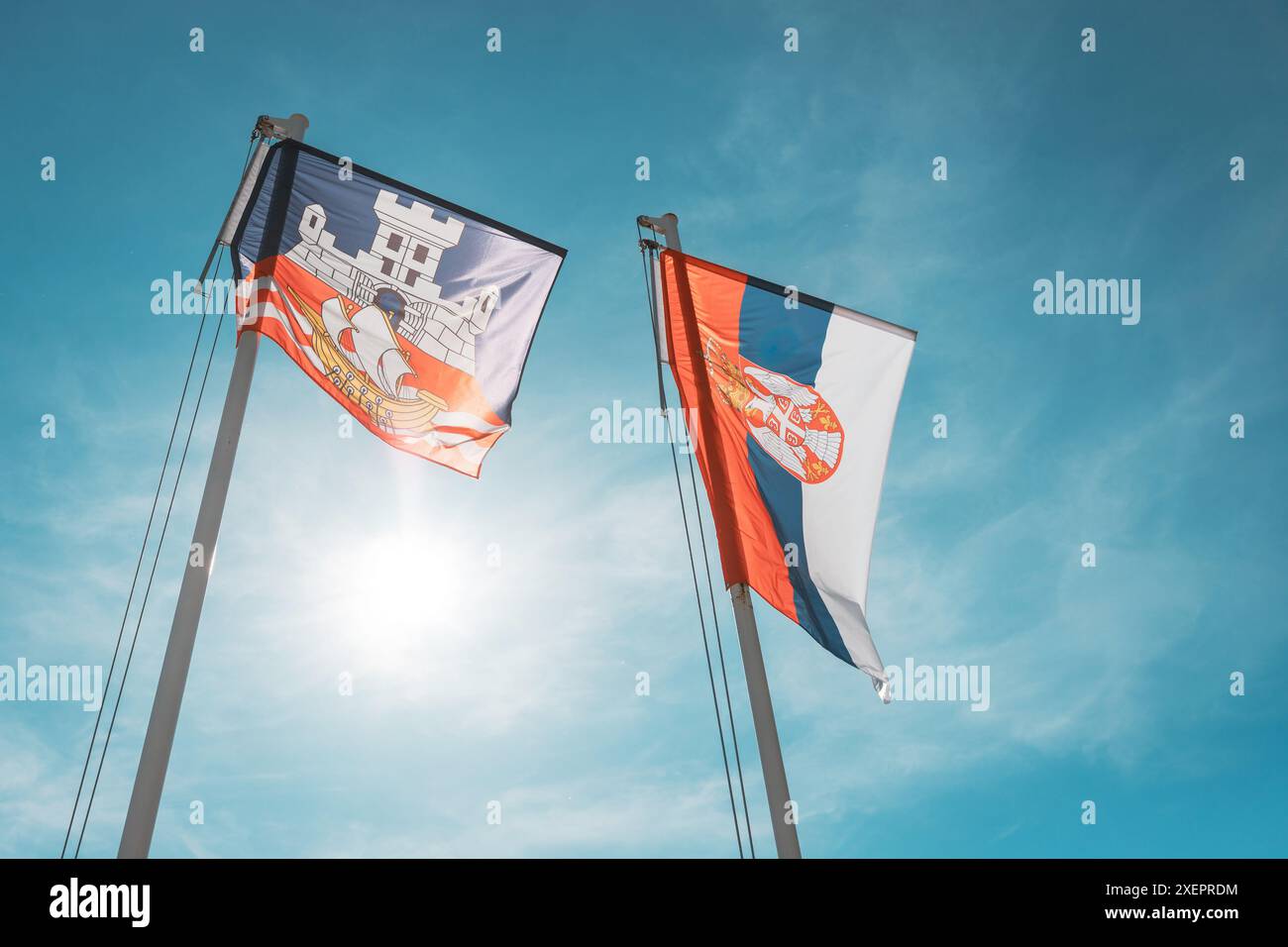 Against the backdrop of the Belgrade sky, the Serbian flag waves ...