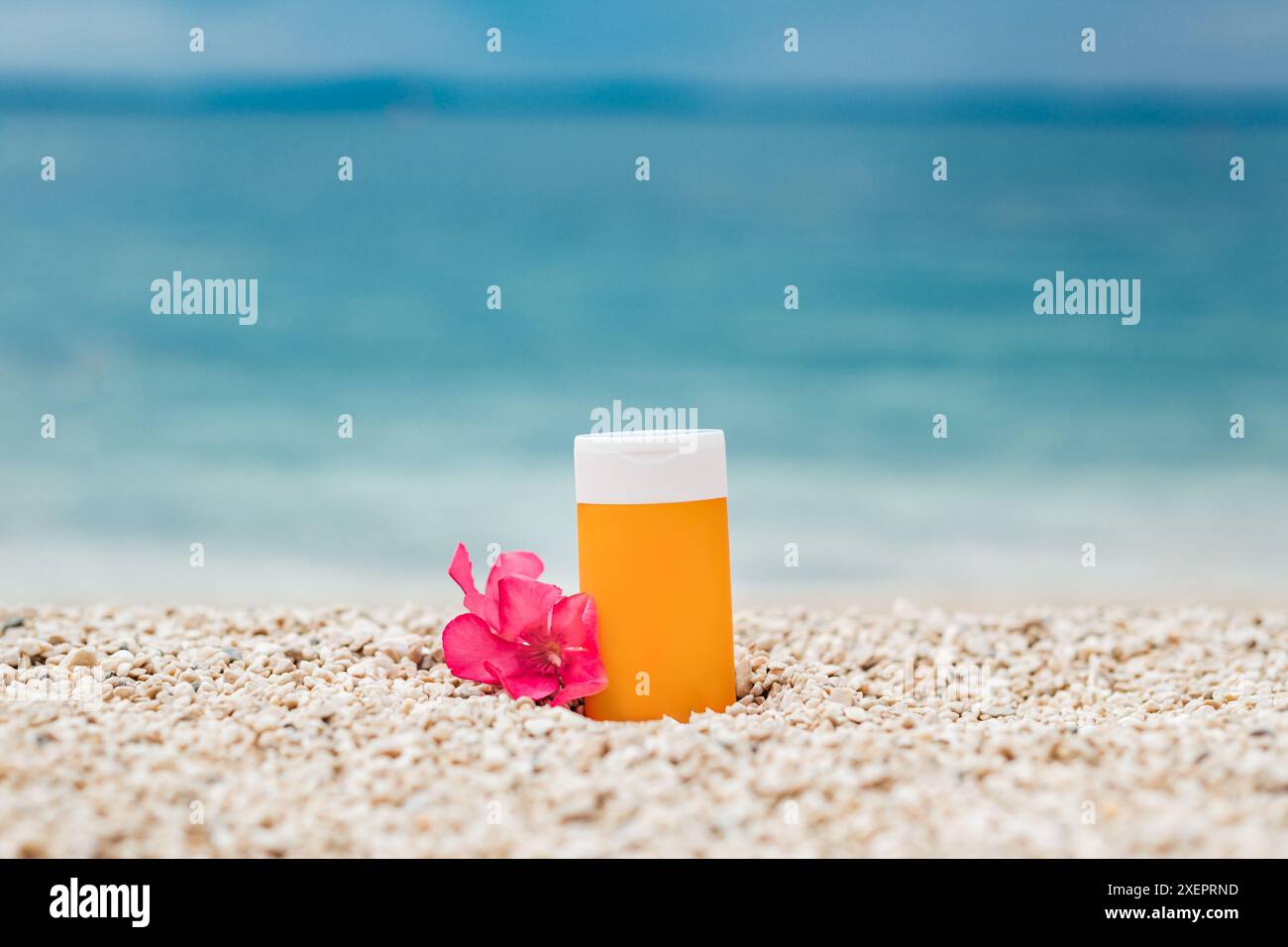 Sunscreen bottle on the beach Stock Photo - Alamy