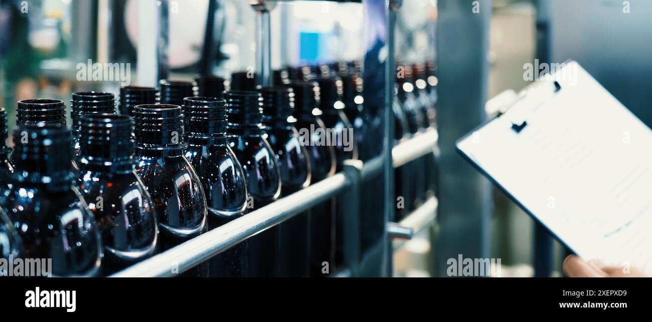 Bottles filling automation machine in modern factory. Technology ...