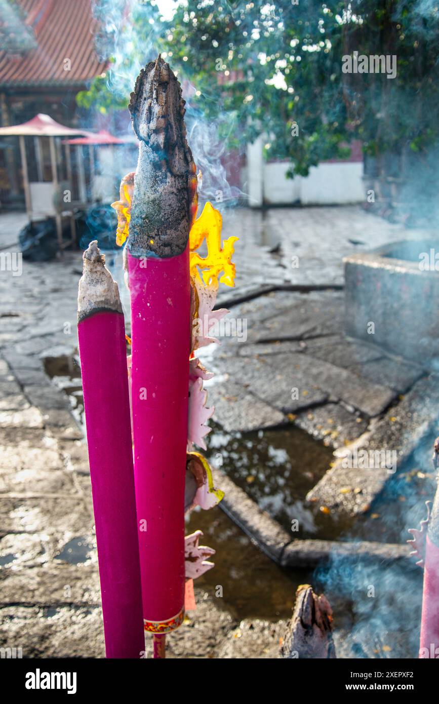 Huge red purple joss sticks are burning contantly,at a Hindu temple in ...