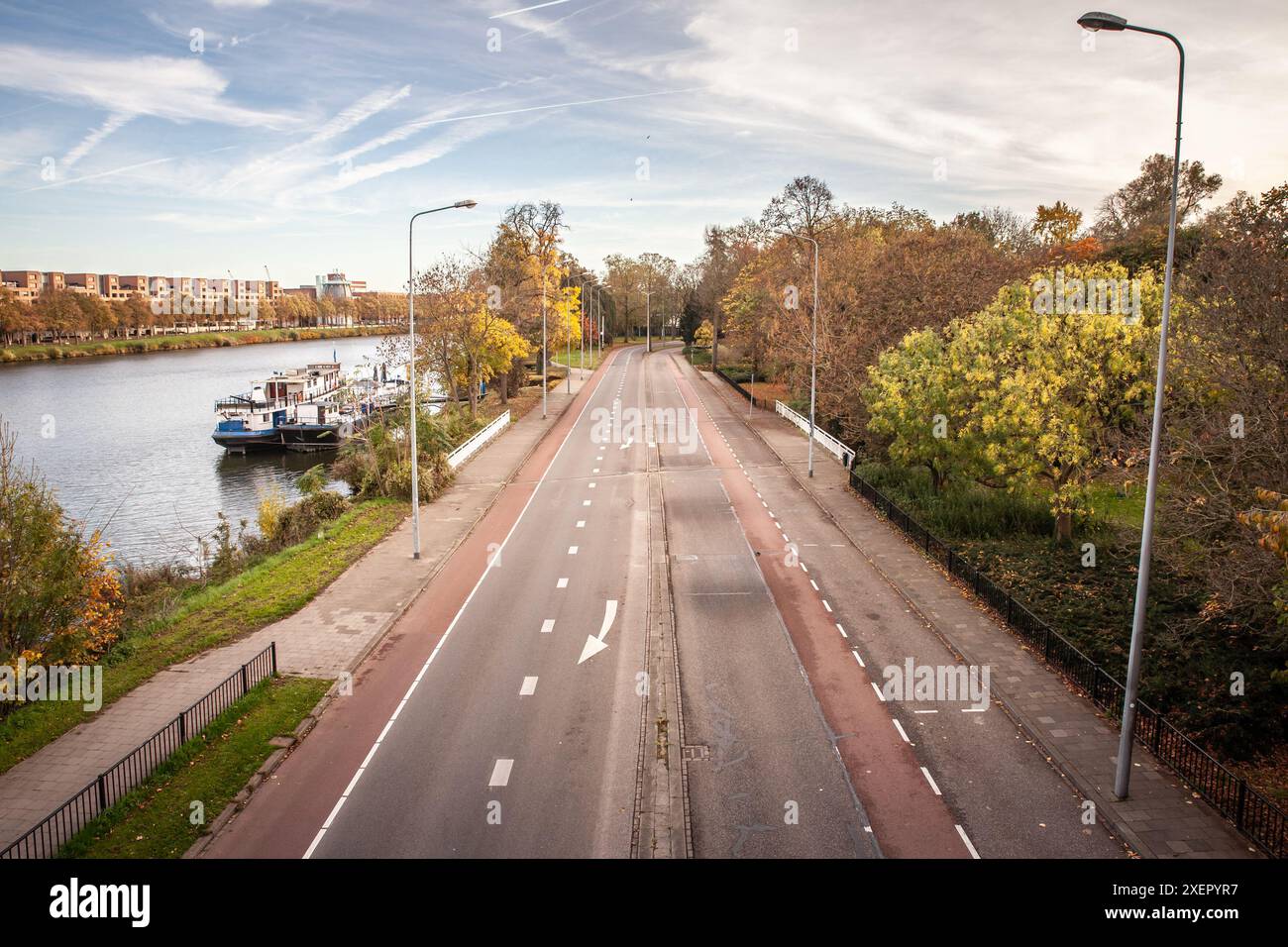 A four-lane street runs alongside the Maas River in Maastricht, with ...