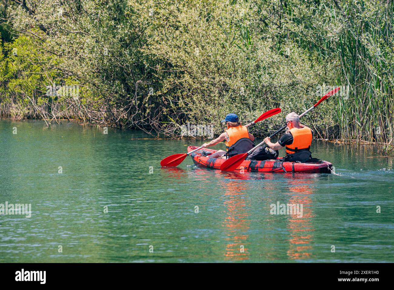 08 May 2024, Virpazar, Montenegro: Happy couple kayaking together on ...