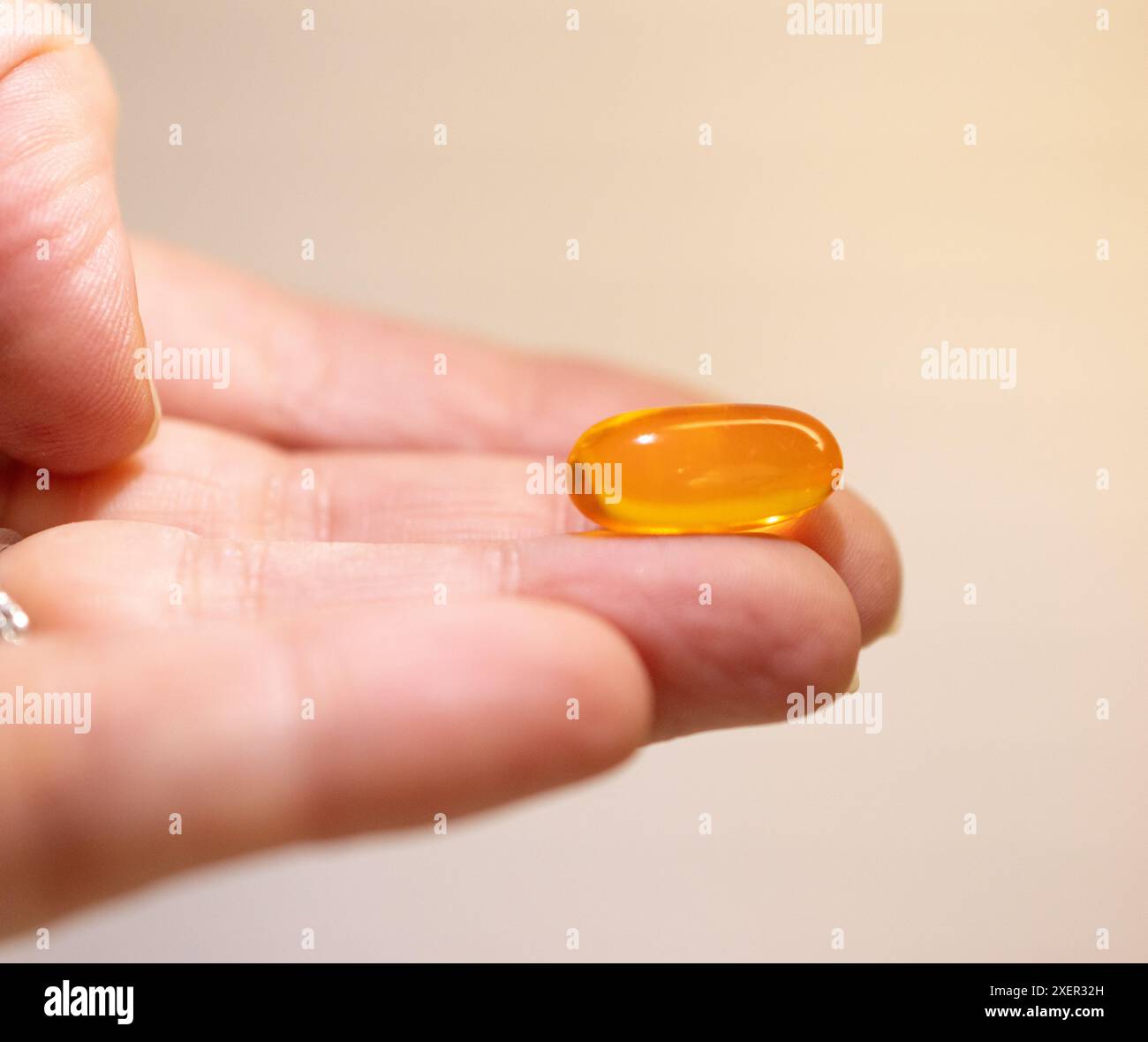 Close-up photo of hand holding a transparent soft capsule Stock Photo ...