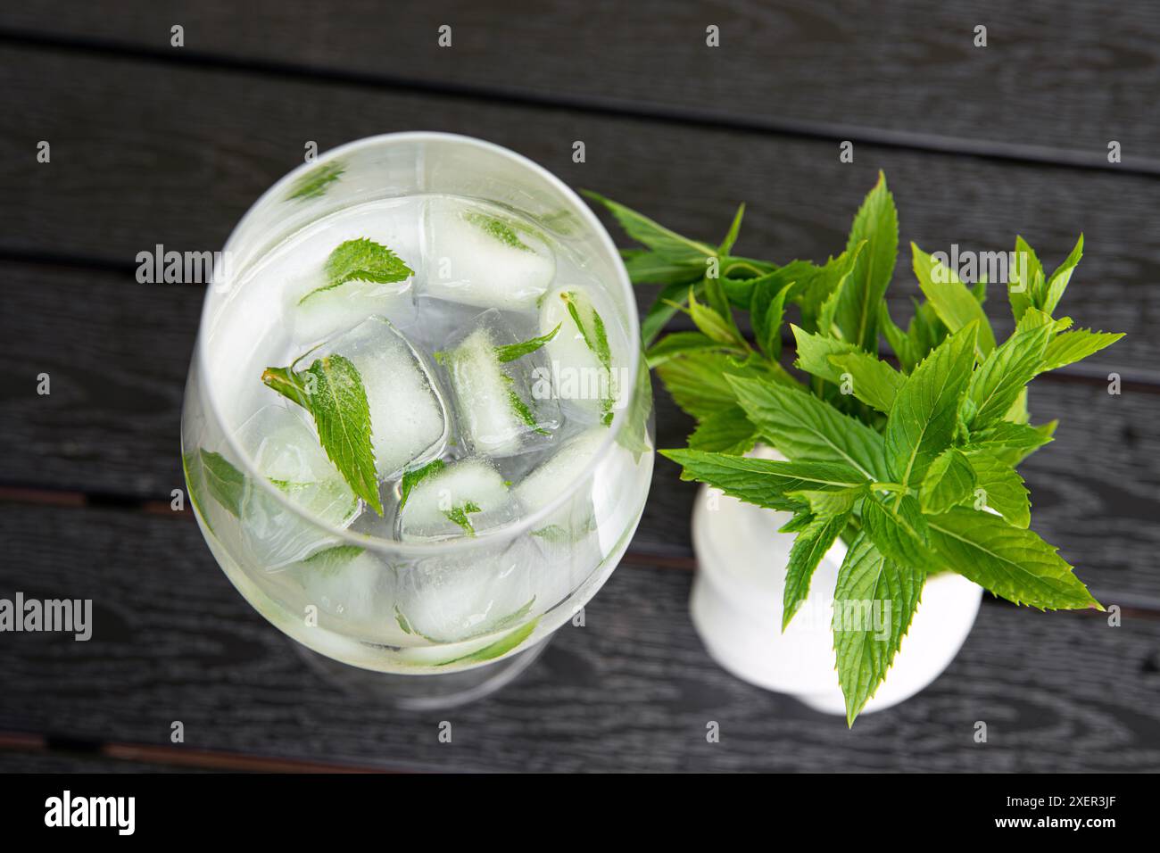 Green fresh peppermint Mentha piperita leaf inside ice cube in glass in ...