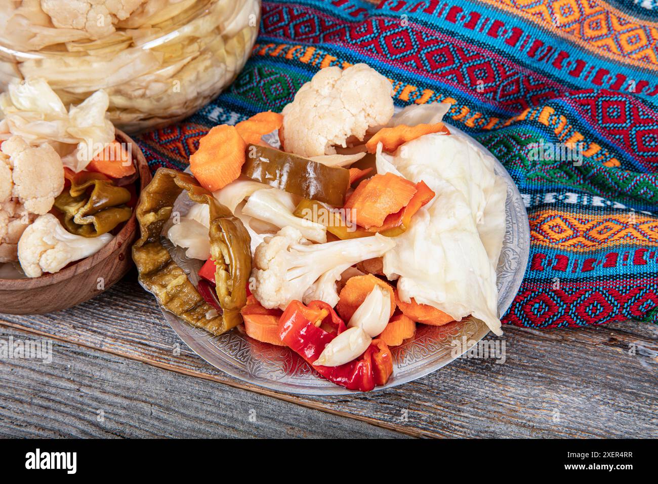 Mixed Pickled vegetables marinated in plastic jar. Colorful marinated ...