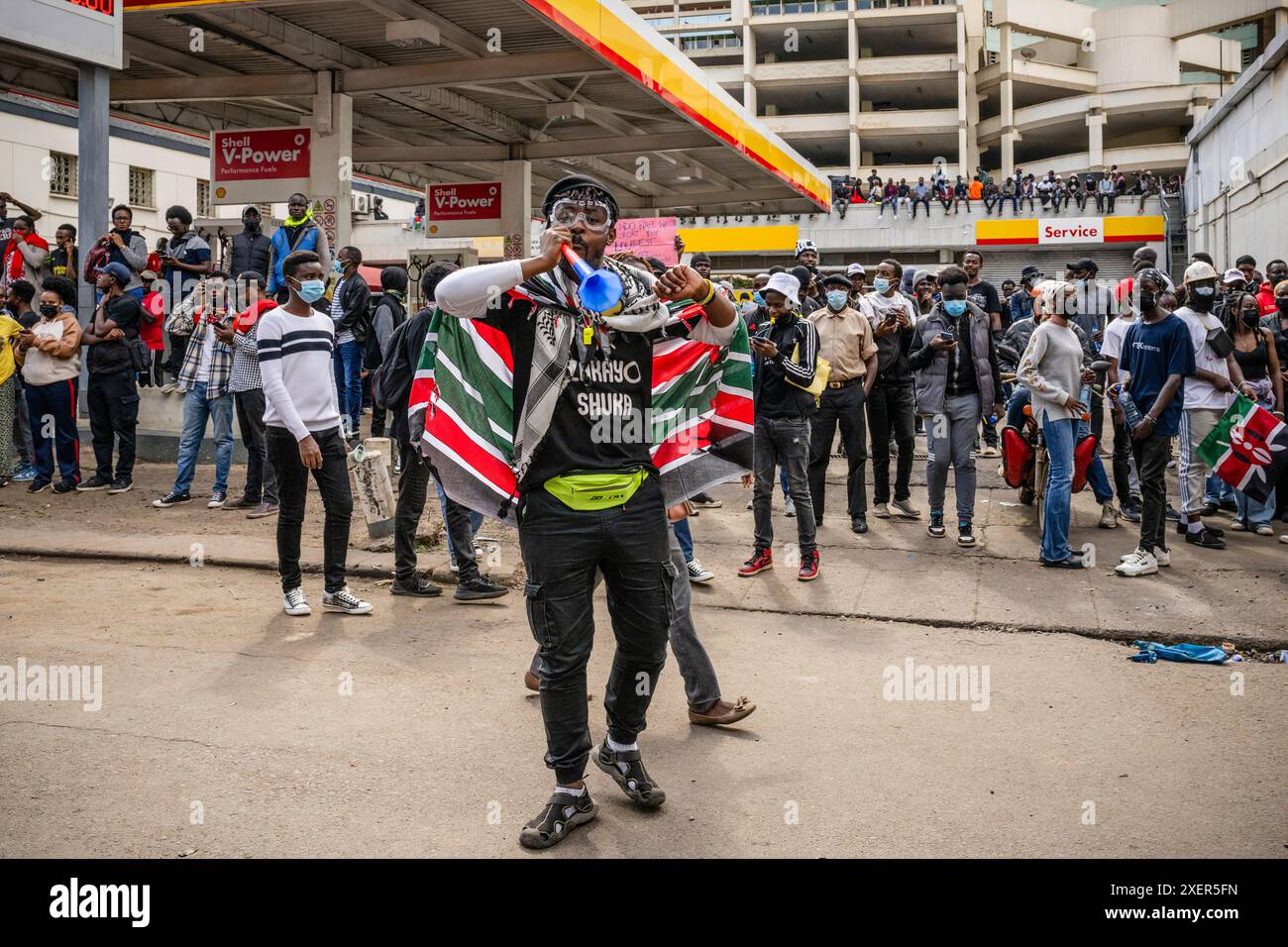 Nairobi, Kenya. 25th June, 2024. A protester blows a vuvuzela during ...
