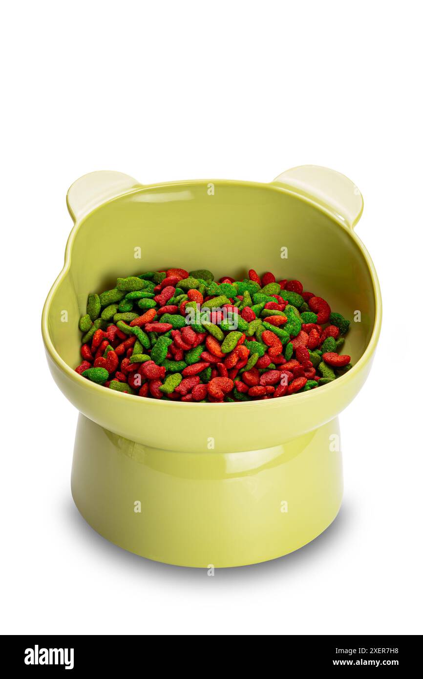 High angle view of colorful dry cat food in green plastic bowl isolated ...