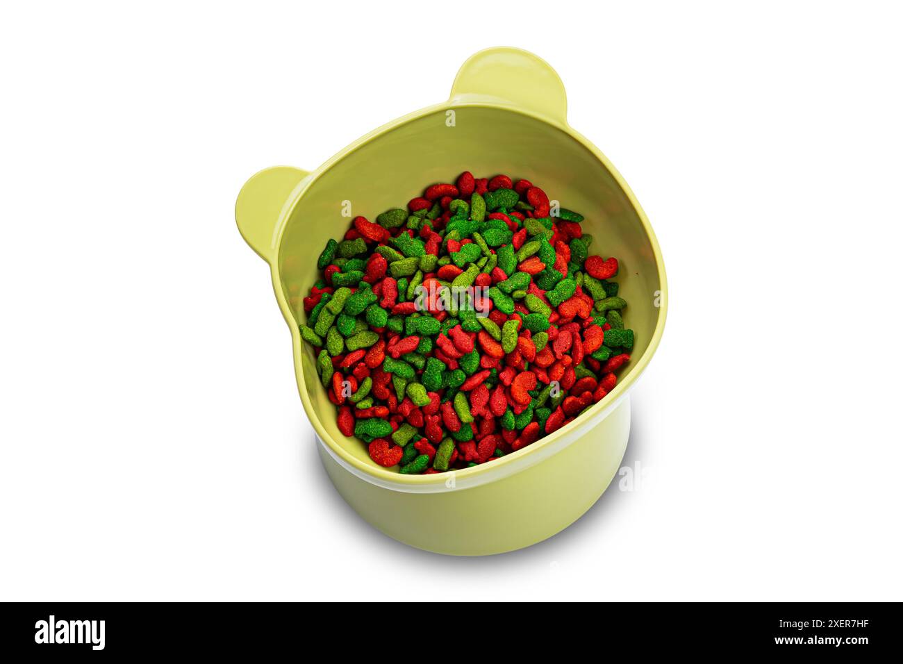 High angle view of dry red and green colors cat food in plastic bowl ...