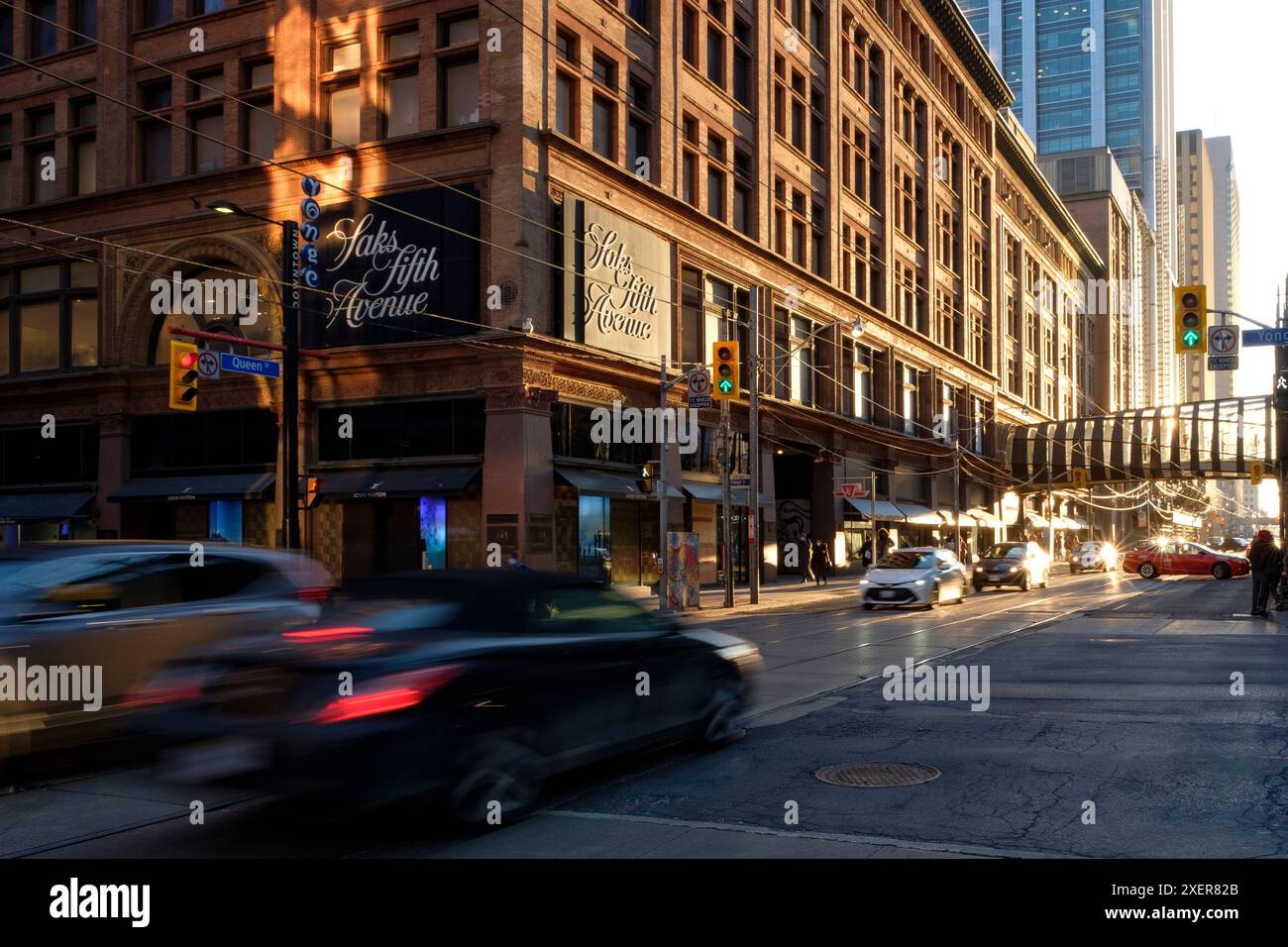 Cars at a crossroads in downtown Toronto. Here is Queen Street and ...
