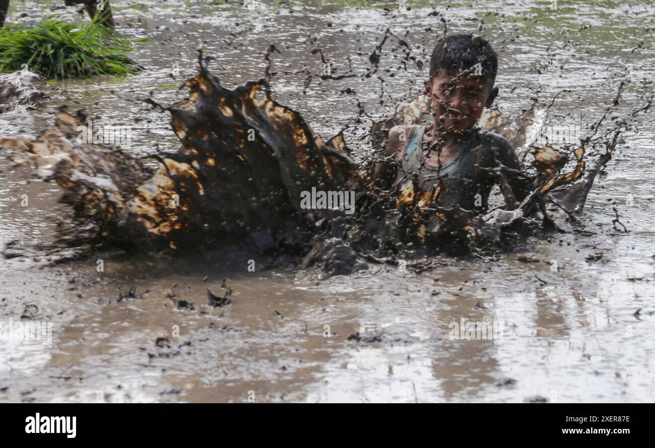 June 29, 2024: A small kid jumps in the muddy water during National ...