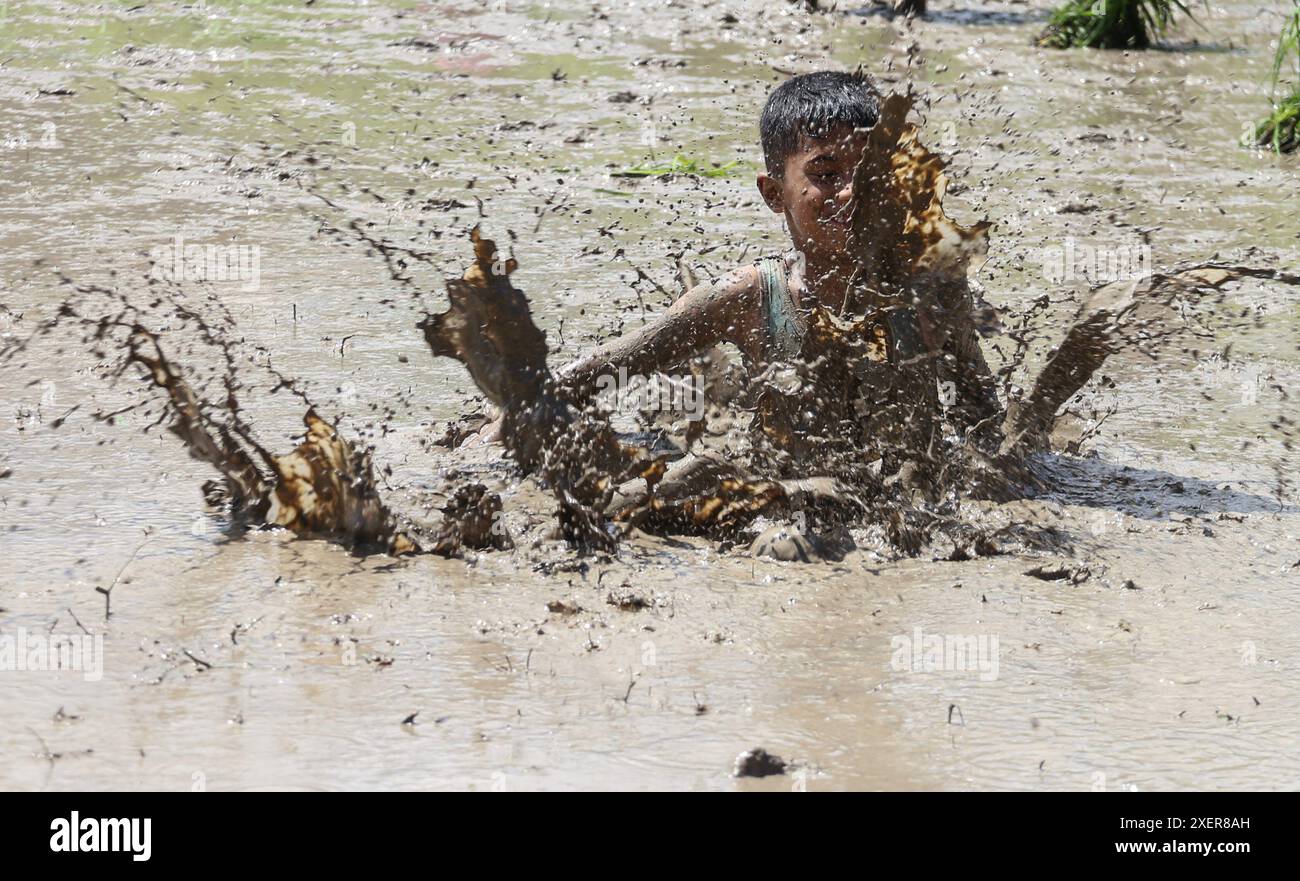 June 29, 2024: A small kid jumps in the muddy water during National ...