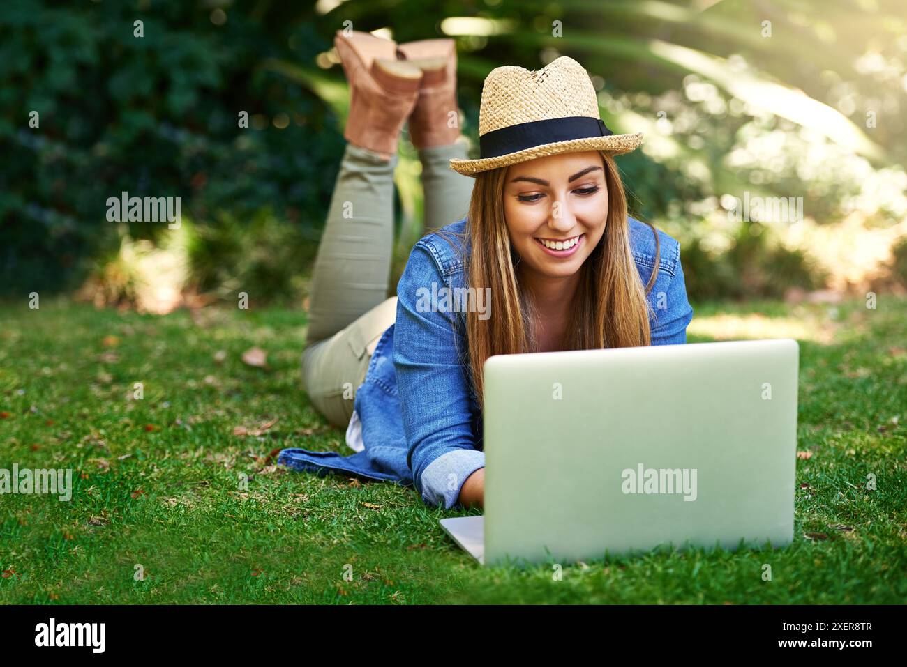 Education, laptop and smile with student woman outdoor on grass for ...