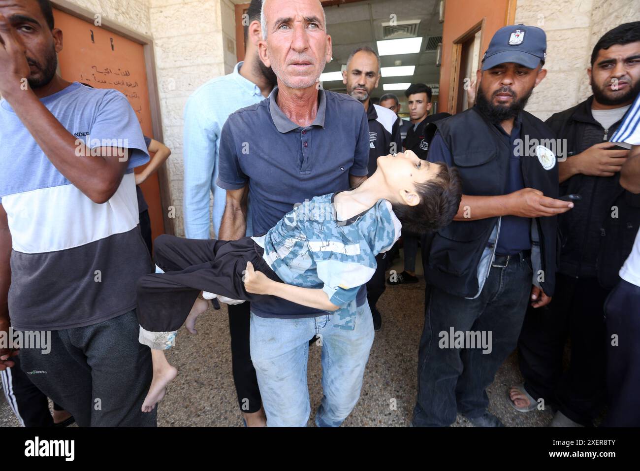 Relatives of the Palestinians died in Israeli attacks, mourn as they receive the dead bodies ...