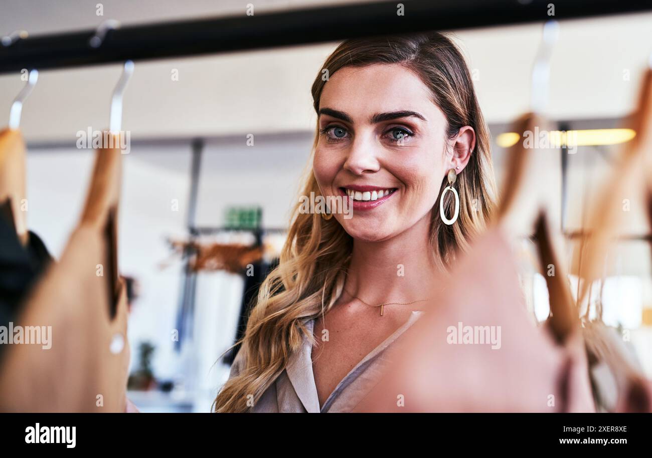Happy woman, portrait and shopping with clothing line on rack for ...