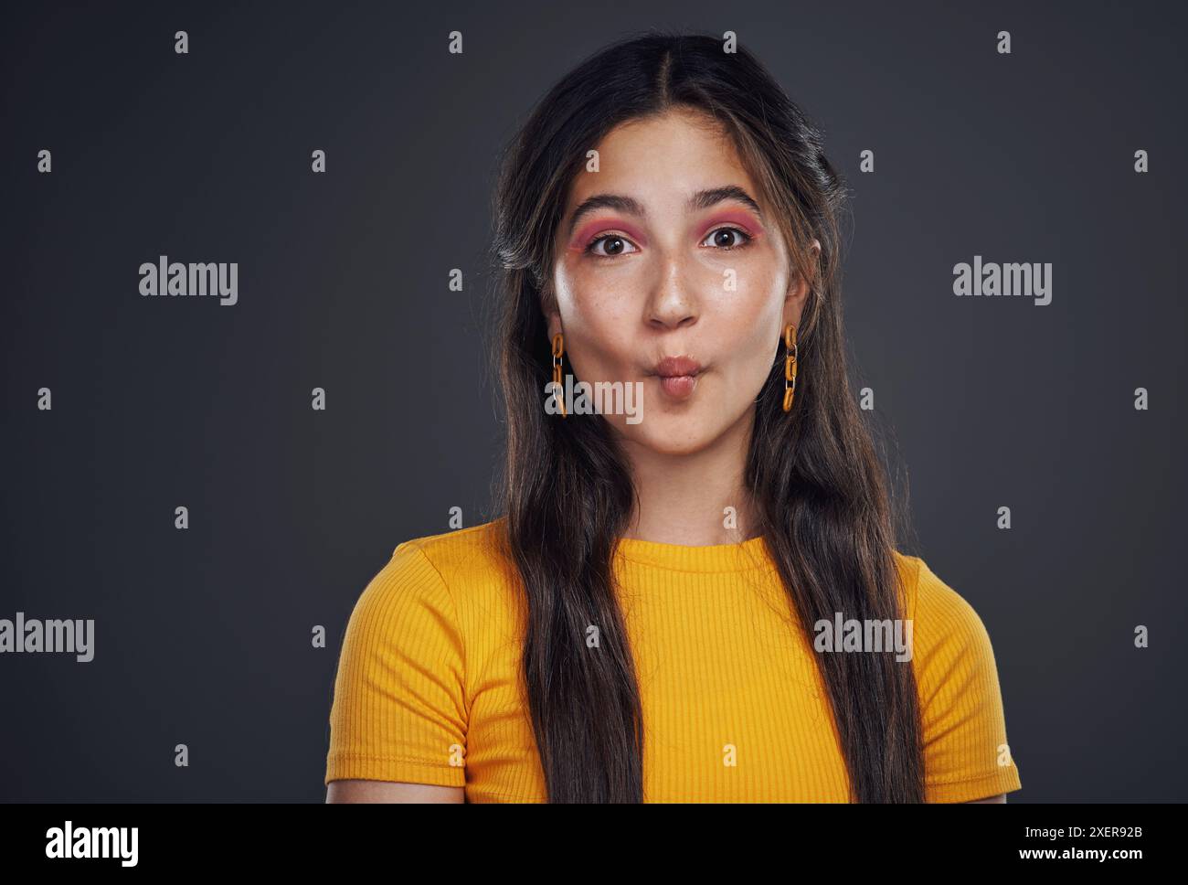 Goofy, expression and portrait of girl in studio for comedy, funny joke ...