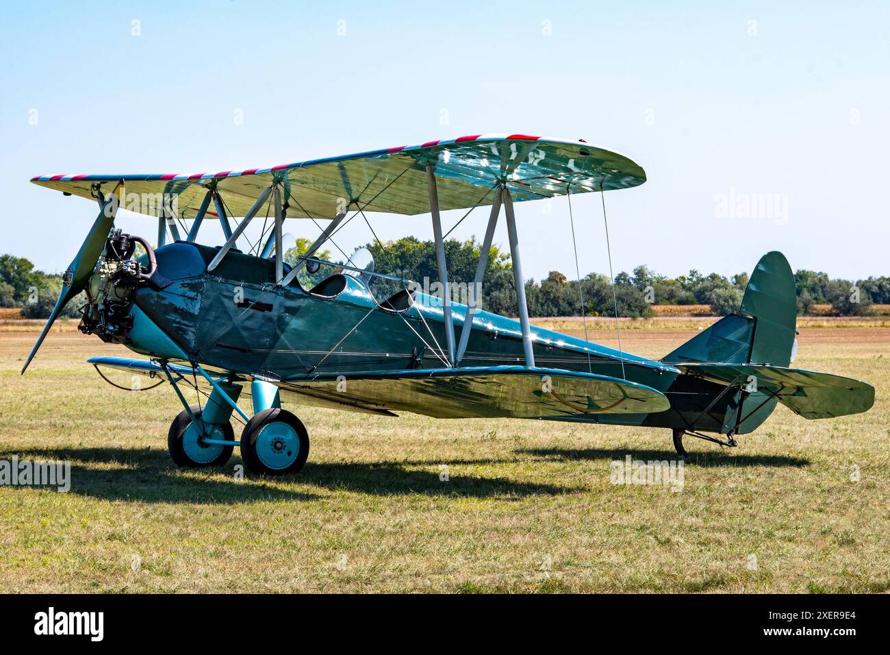 WWII green painted Soviet Po-2 military biplane on a grass airfield ...