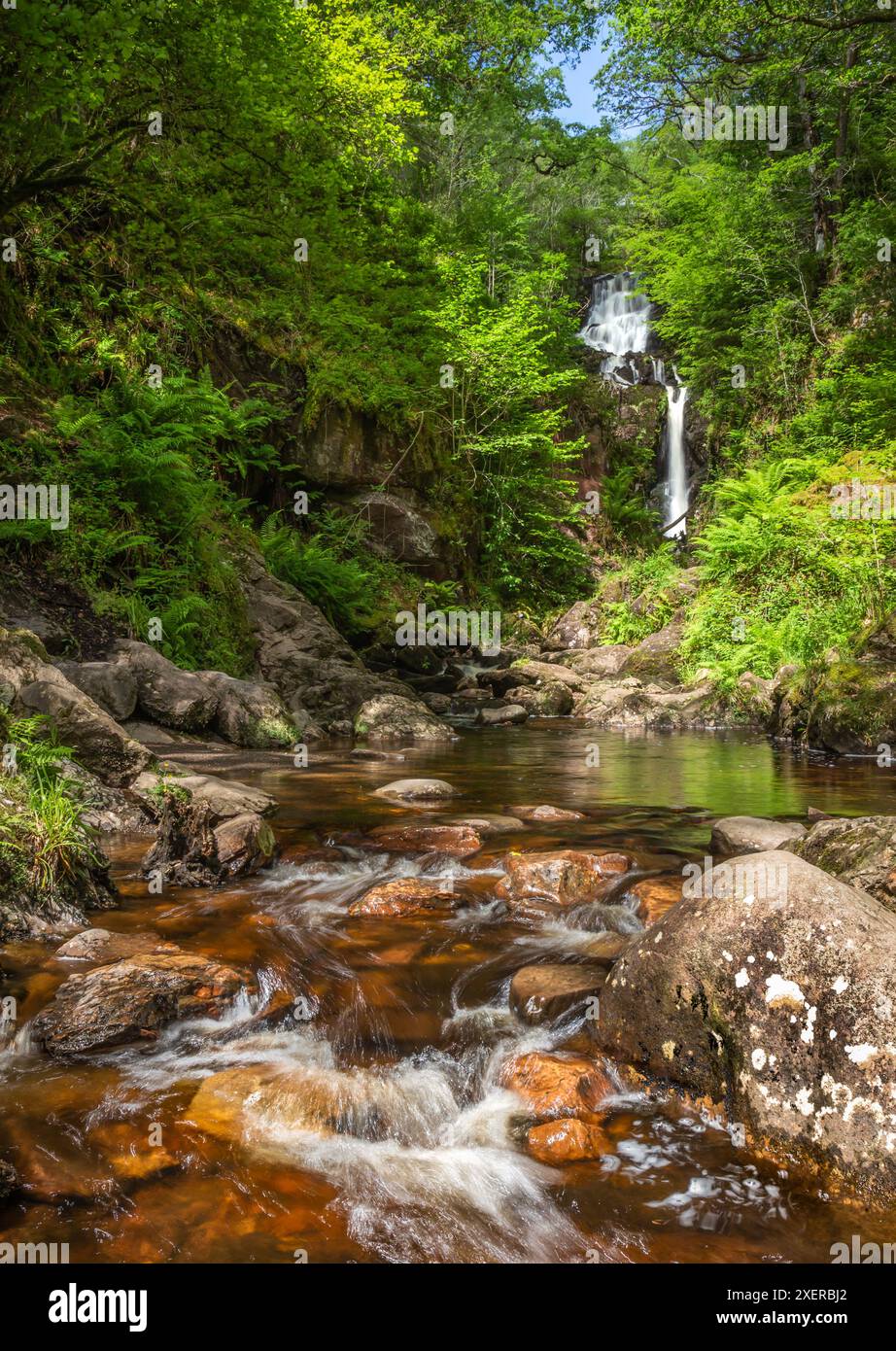 Vertical image of a river in Aberfoyle, Scotland, with waterfall in ...
