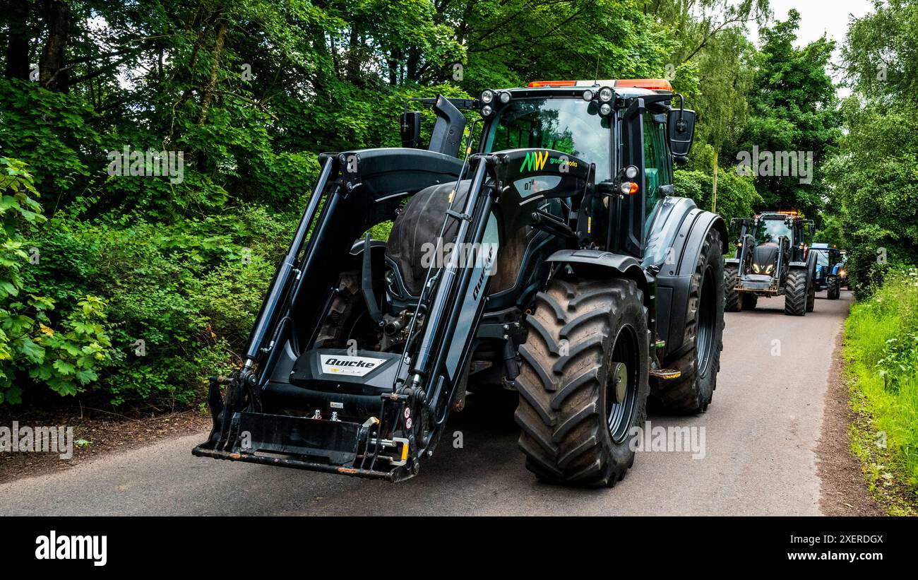Tractors taking part in a fun charity rally on country roads in South ...