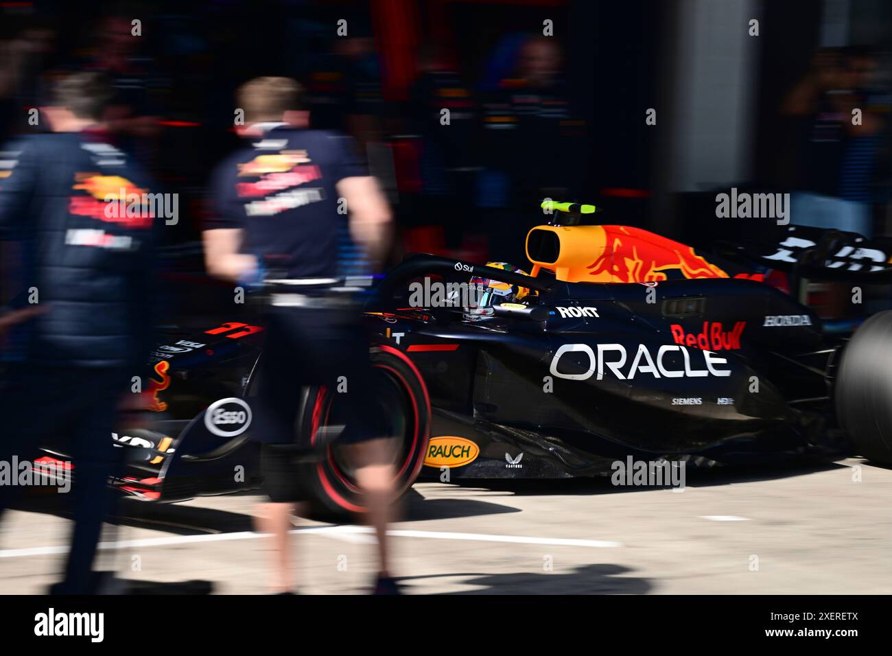 Red Bull driver Sergio Perez of Mexico steers his car on the pit lane, during the qualifying for ...