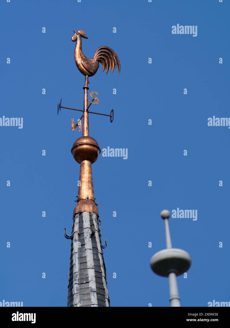 A weather vane on a church tower, here a catholic church in Altena ...