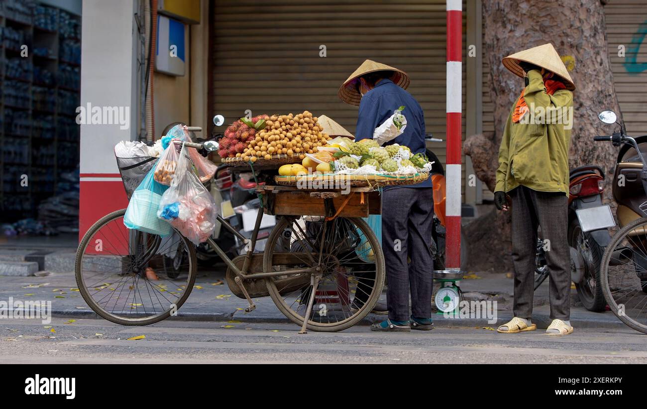 A Vietnamese street vendor woman, dressed in a traditional Asian ...