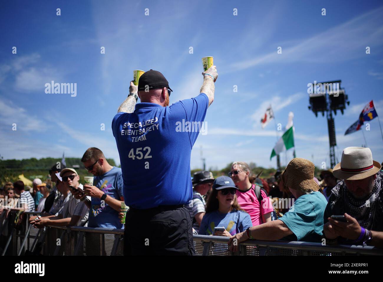 A member of pit security handing out water to the crowd watching Femi ...